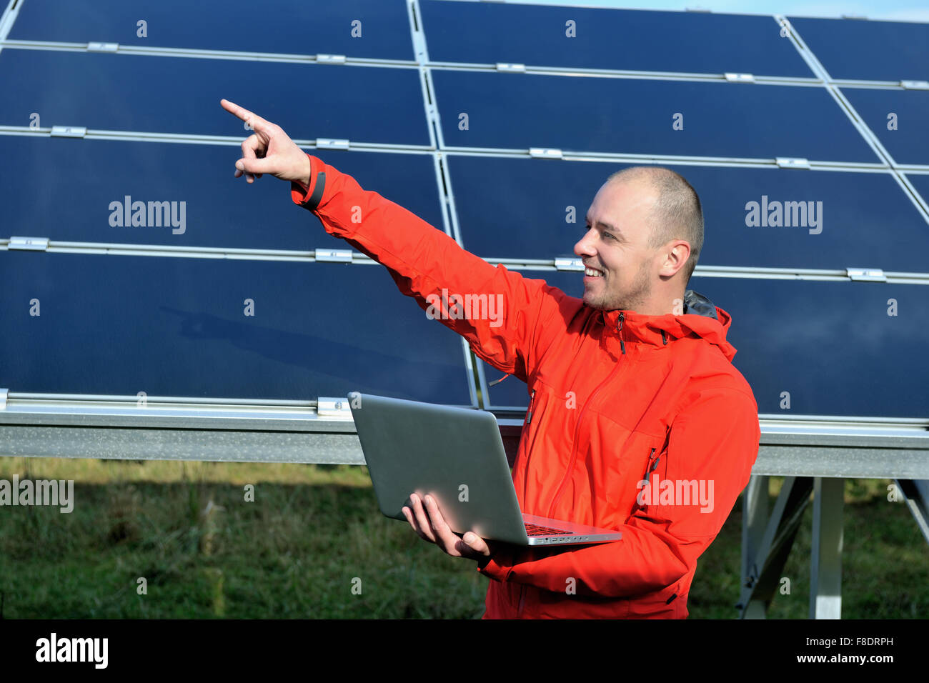 business man engineer using laptop at solar panels plant eco energy ...