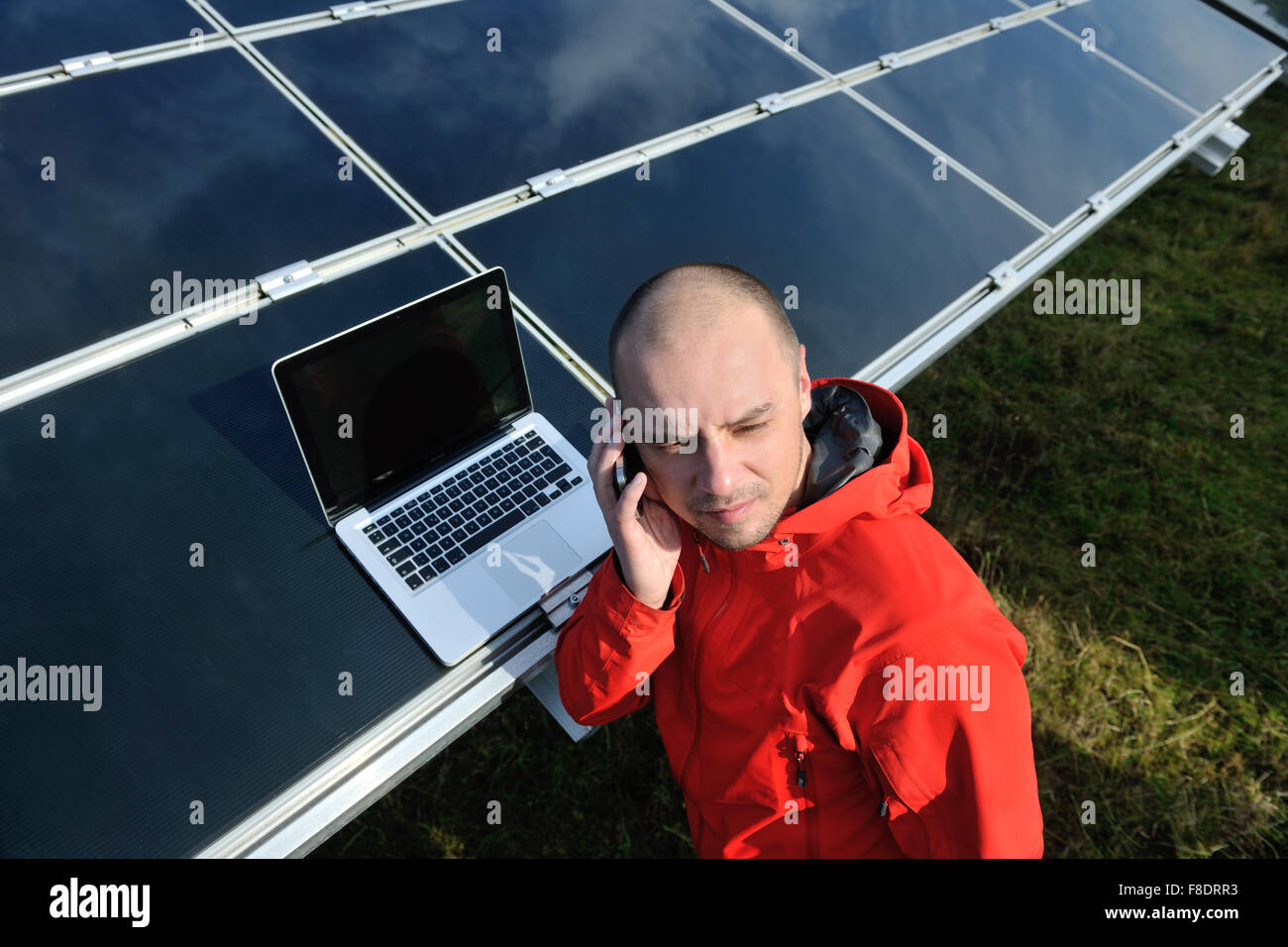 business man engineer using laptop at solar panels plant eco energy ...