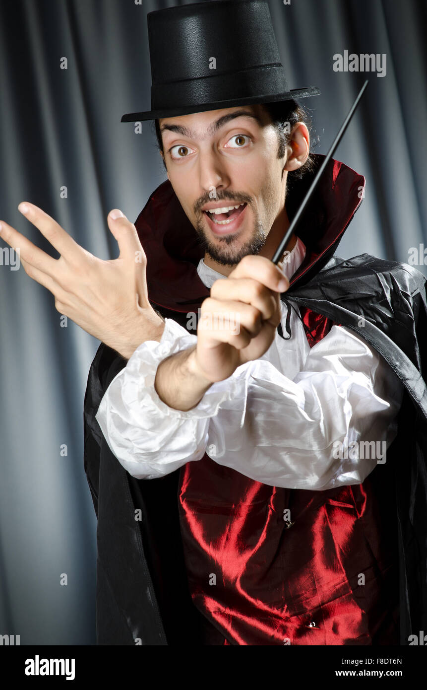 Magician doing tricks on white Stock Photo - Alamy