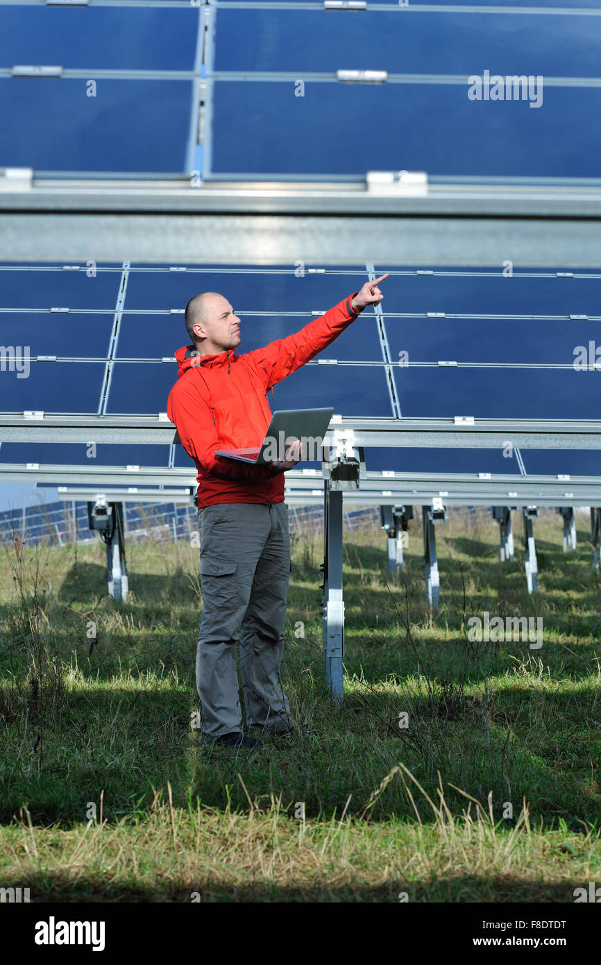 business man engineer using laptop at solar panels plant eco energy ...