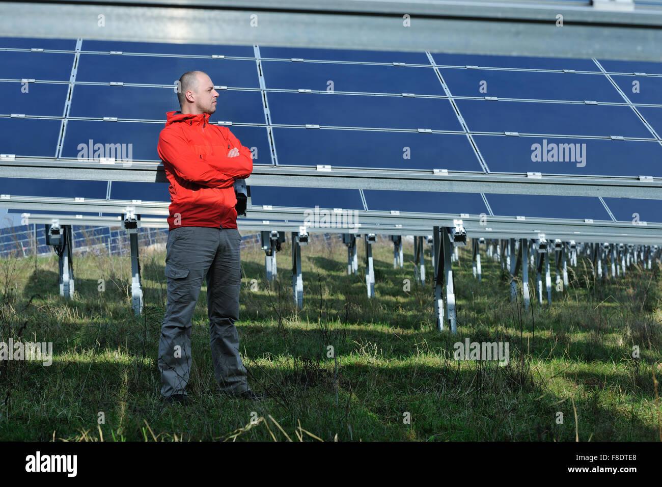 Male engineer at work place, solar panels plant industy in background ...