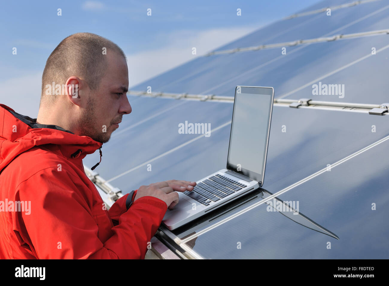 business man engineer using laptop at solar panels plant eco energy ...