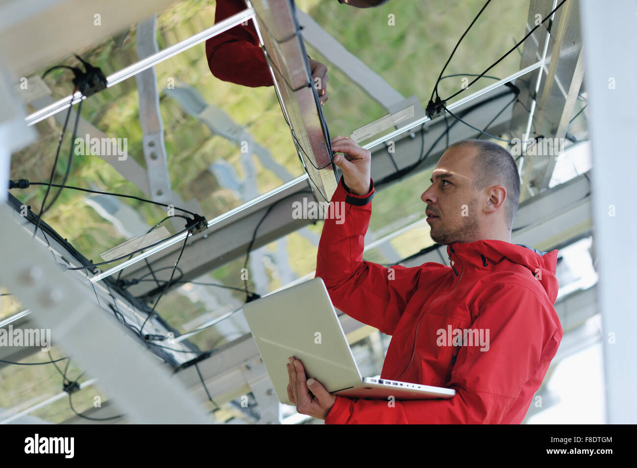 business man engineer using laptop at solar panels plant eco energy ...