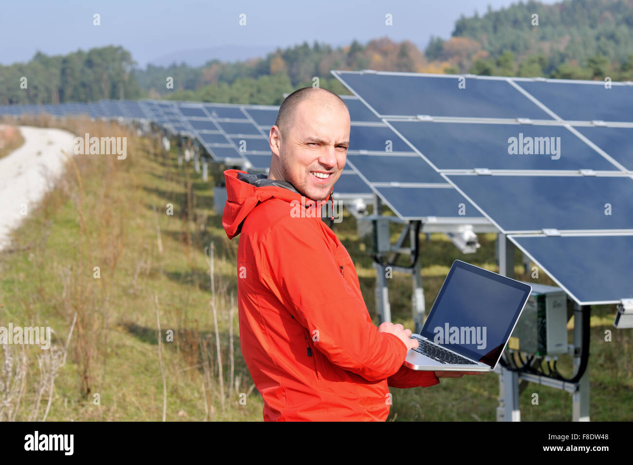 business man engineer using laptop at solar panels plant eco energy ...