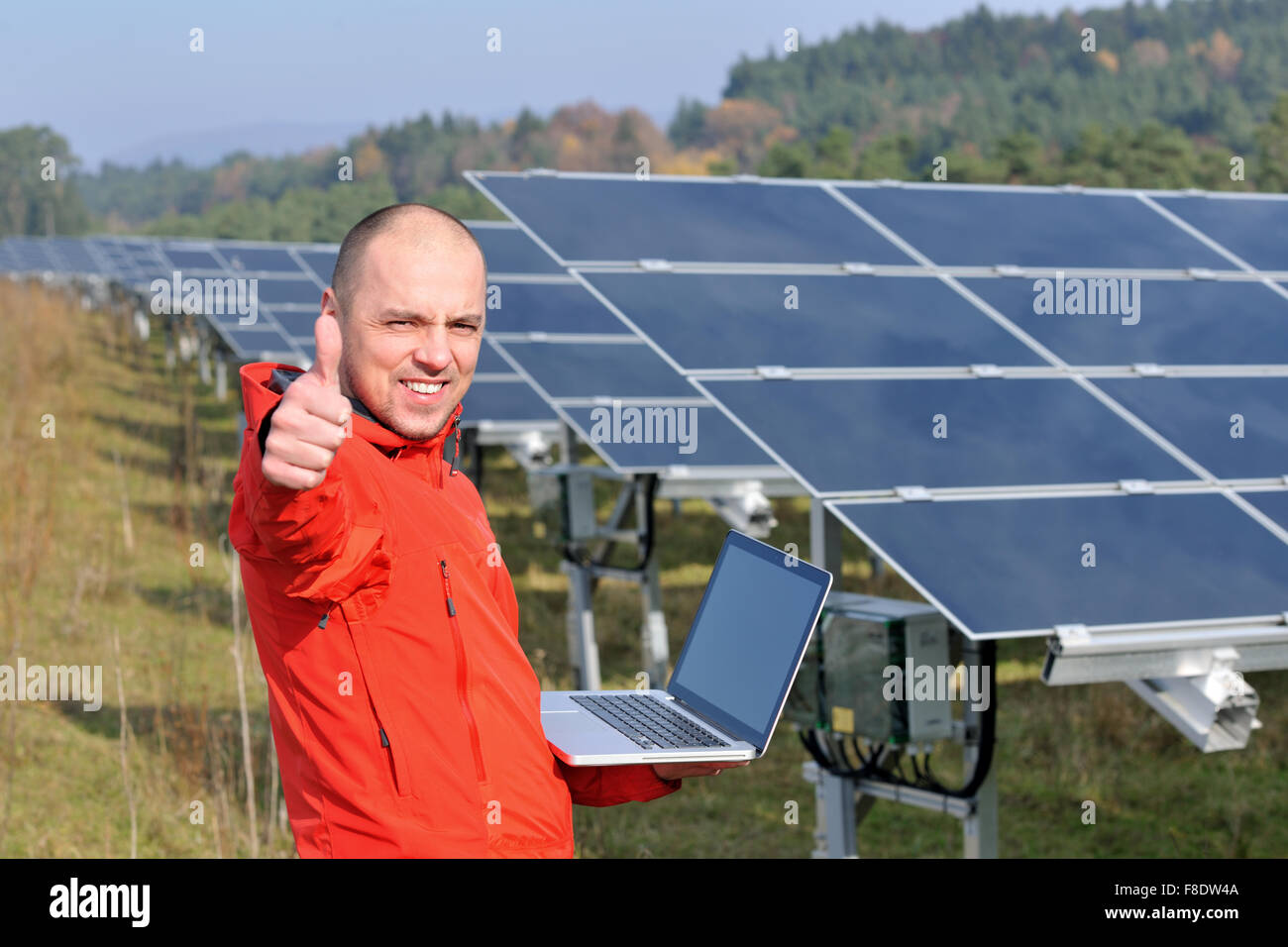 business man engineer using laptop at solar panels plant eco energy ...