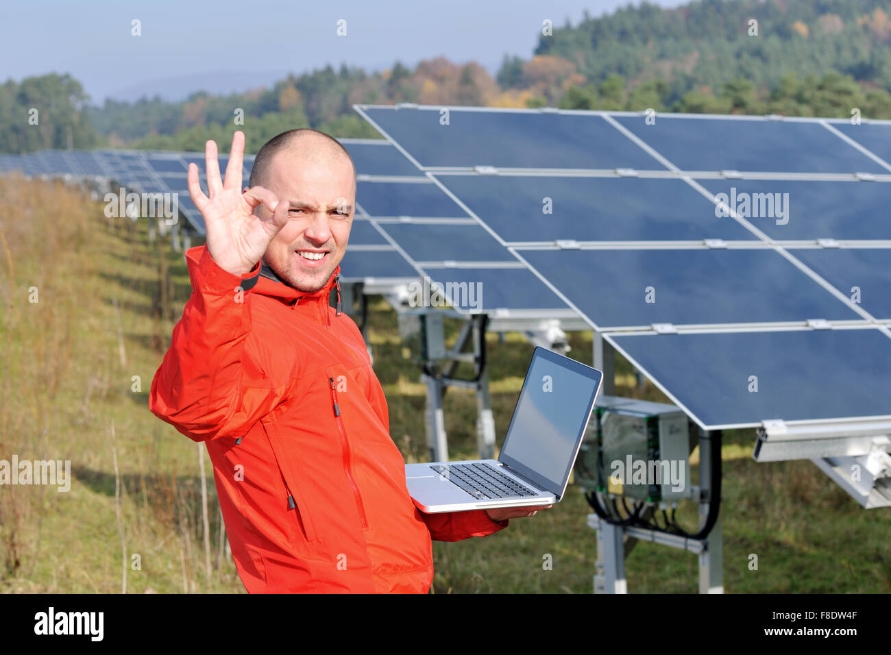 business man engineer using laptop at solar panels plant eco energy ...
