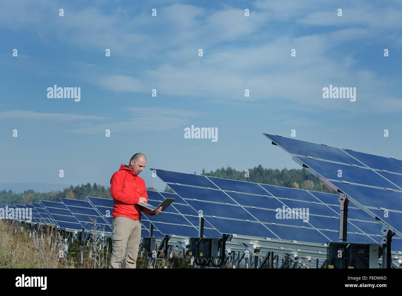 business man engineer using laptop at solar panels plant eco energy ...