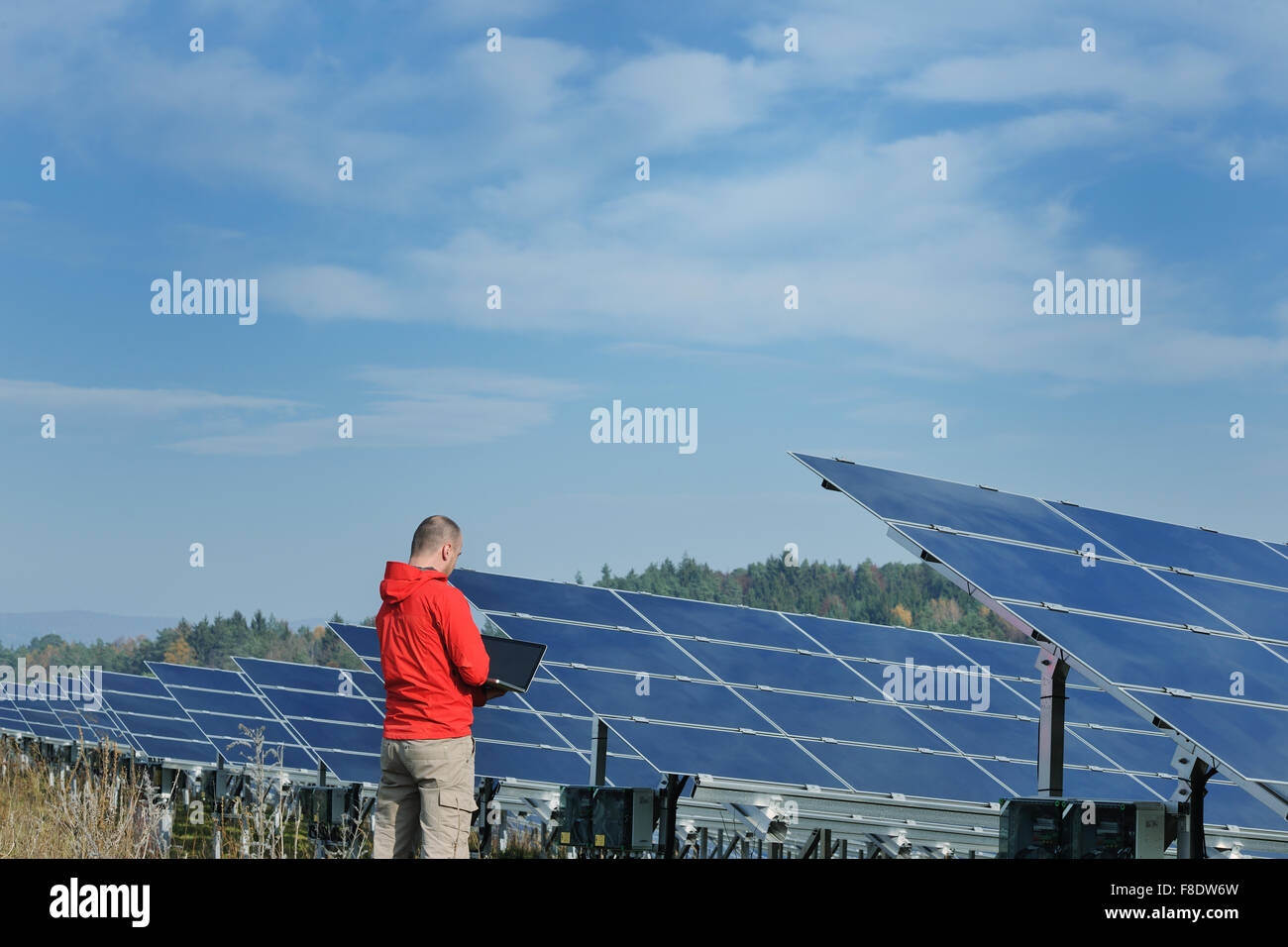 business man engineer using laptop at solar panels plant eco energy ...