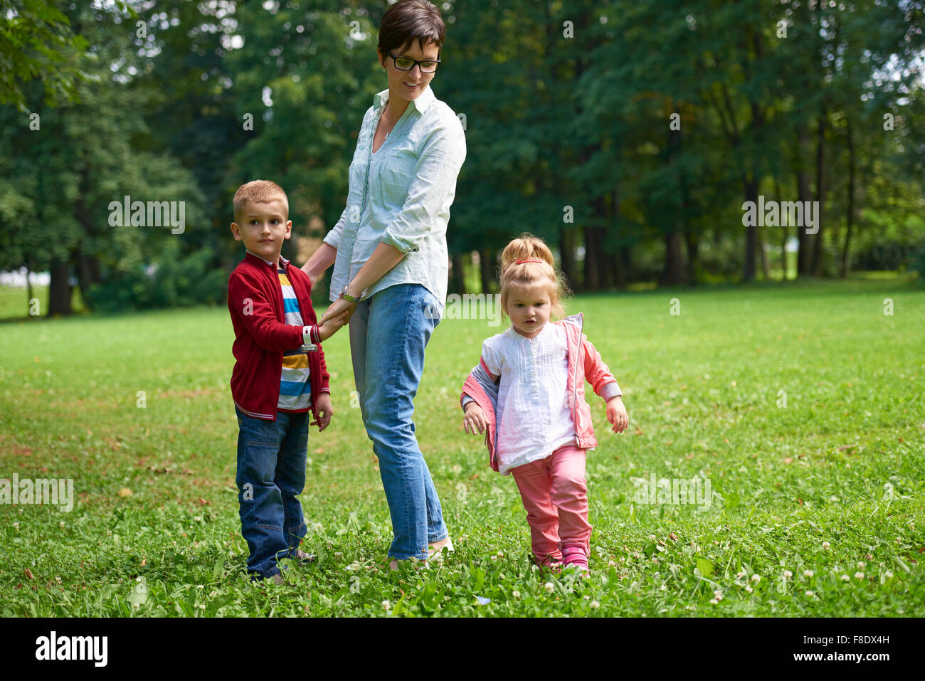 happy family playing together outdoor in park mother with kids running ...