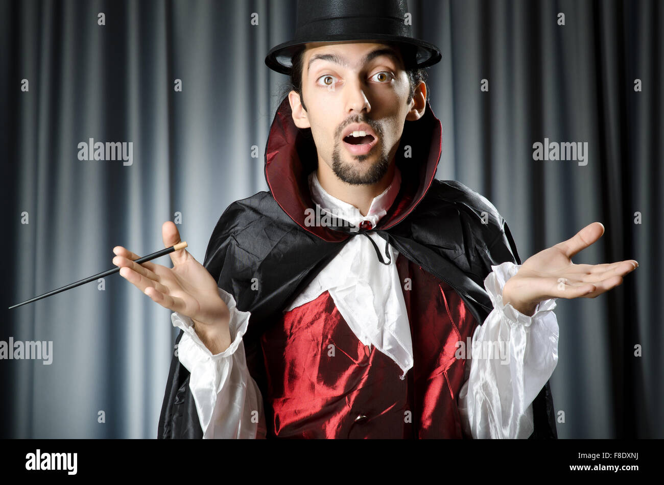 Magician doing tricks on white Stock Photo - Alamy