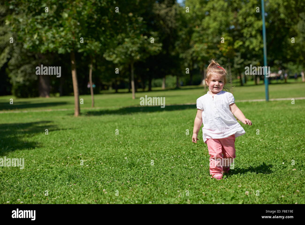 happy little girl have fun in park Stock Photo - Alamy