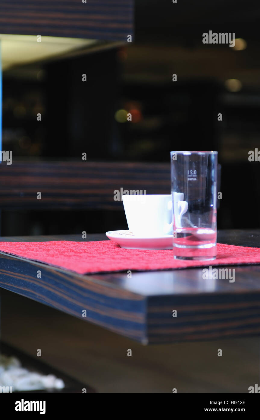 cup of fresh coffeee in restaurant with glass of water Stock Photo - Alamy