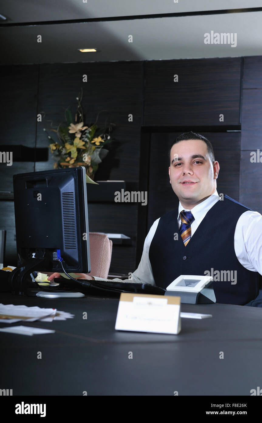reception service man hotel indoor smile travel Stock Photo - Alamy