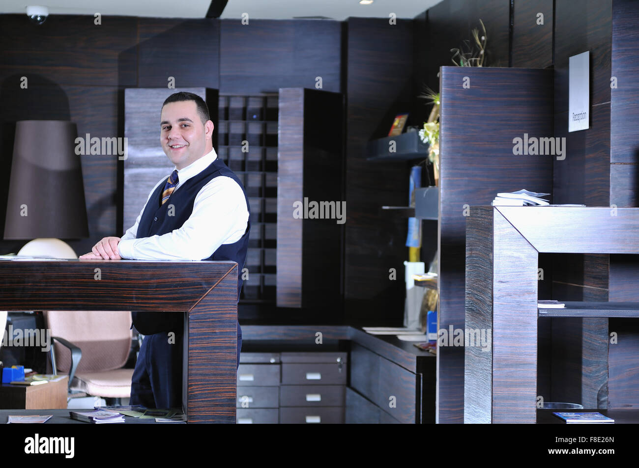 reception service man hotel indoor smile travel Stock Photo - Alamy