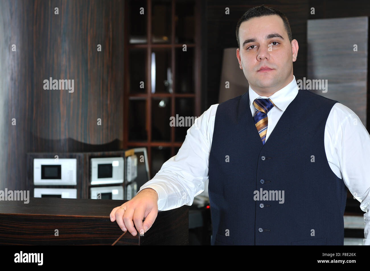 reception service man hotel indoor smile travel Stock Photo - Alamy