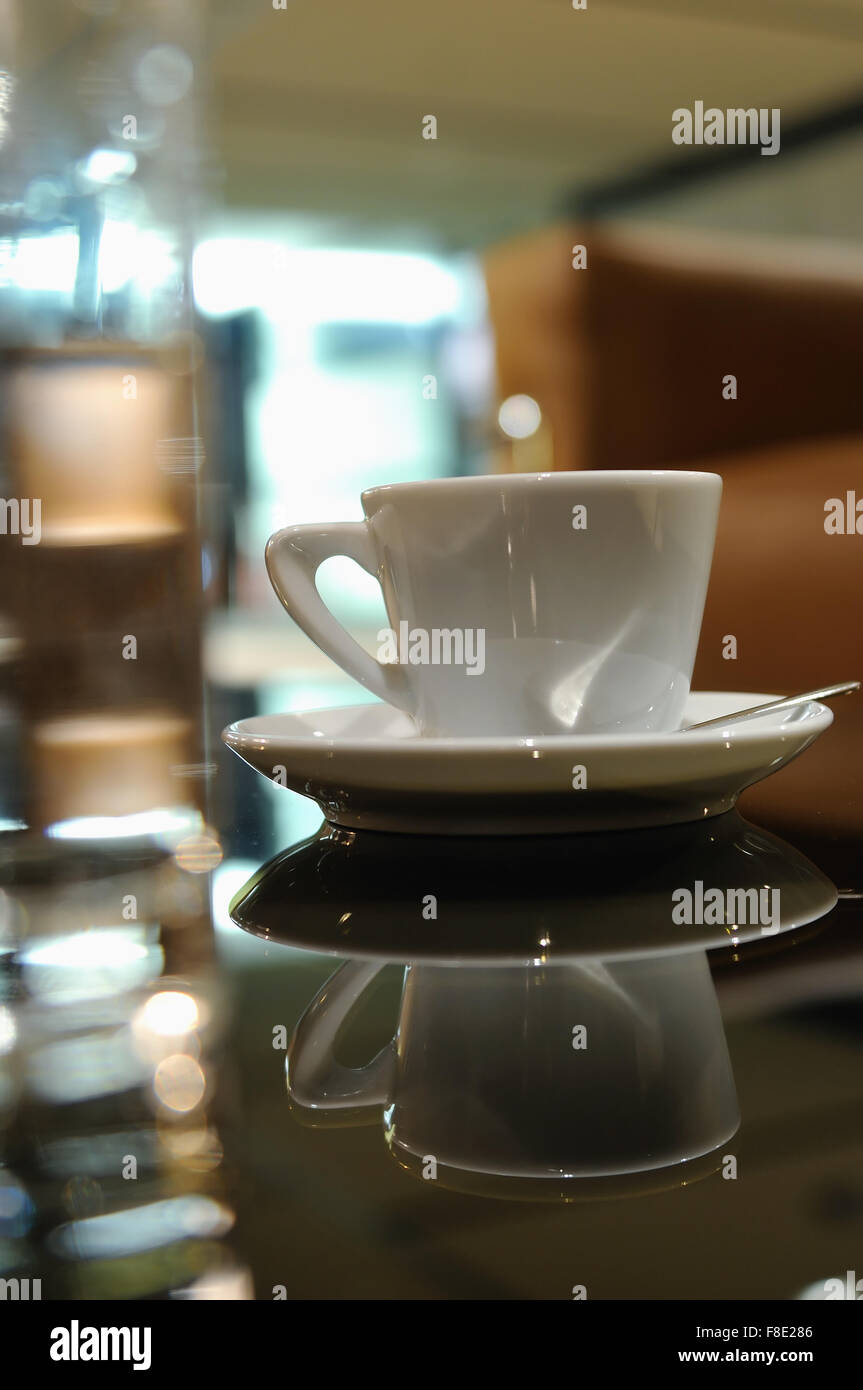 cup of fresh coffeee in restaurant with glass of water Stock Photo - Alamy