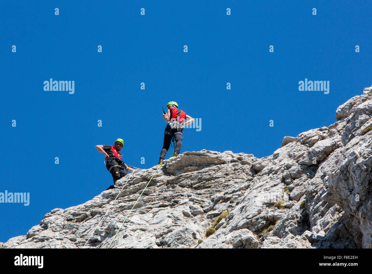 Mountain rescue team members in action in the mountains of Dolomites ...
