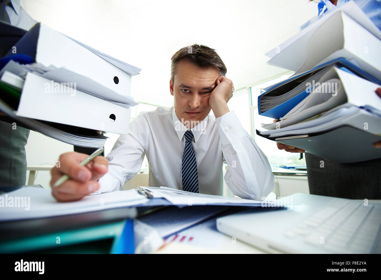 Tired manager have so many paperwork in the office Stock Photo - Alamy
