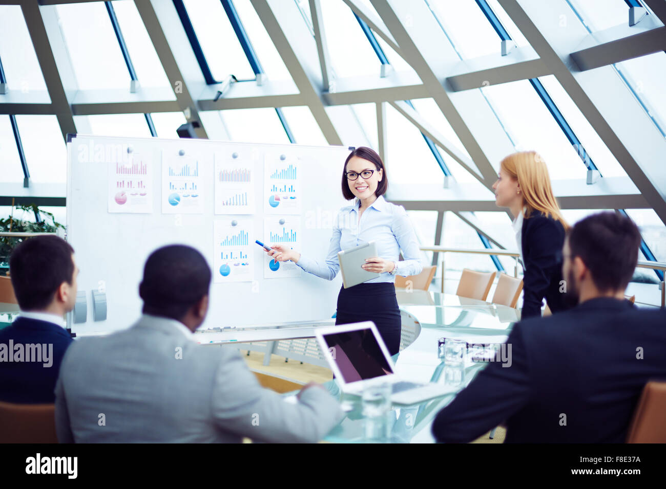 Business team discussing new charts at conference Stock Photo - Alamy