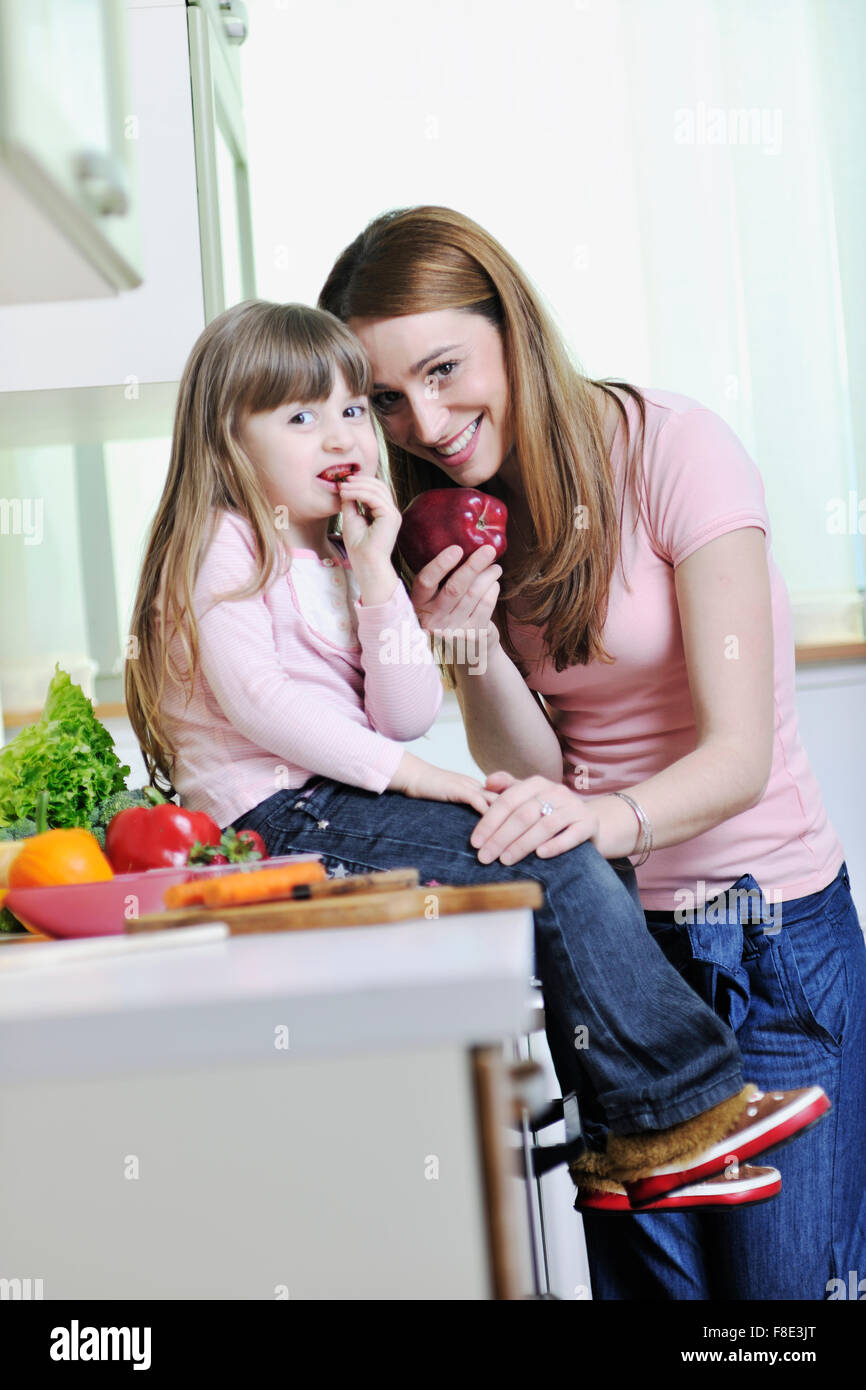 happy young family have lunch time with fresh fruits and vegetable food ...