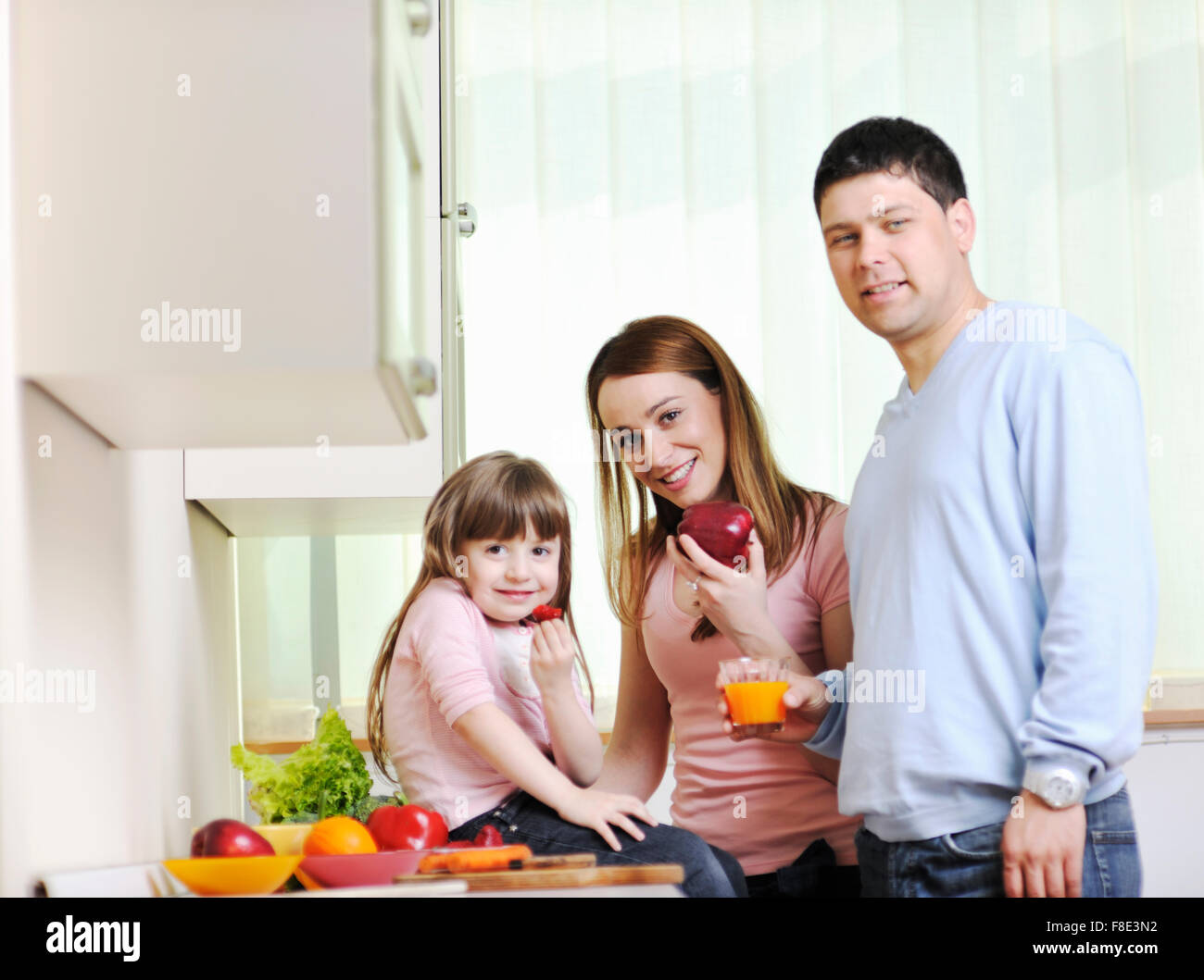 happy young family have lunch time with fresh fruits and vegetable food ...