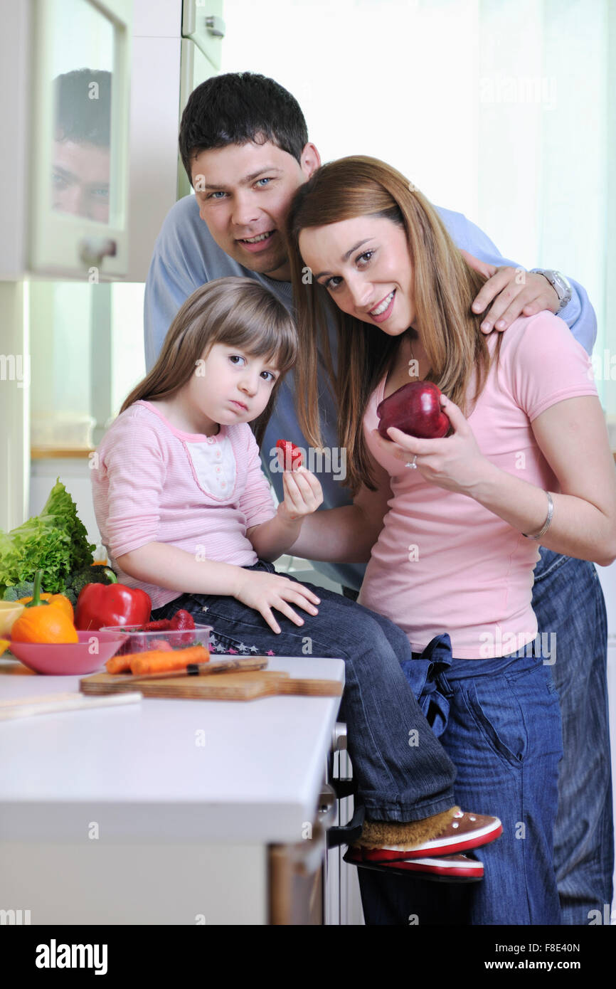 happy young family have lunch time with fresh fruits and vegetable food ...