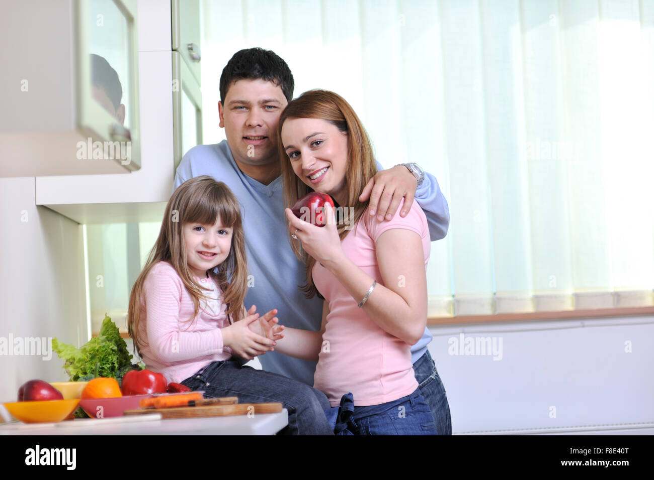 happy young family have lunch time with fresh fruits and vegetable food ...