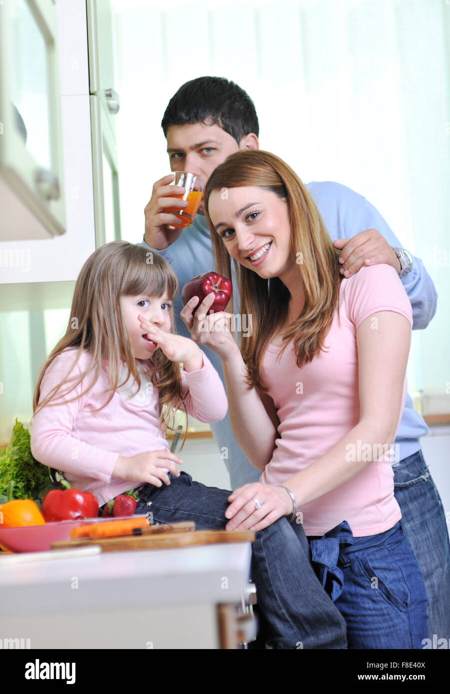 happy young family have lunch time with fresh fruits and vegetable food ...