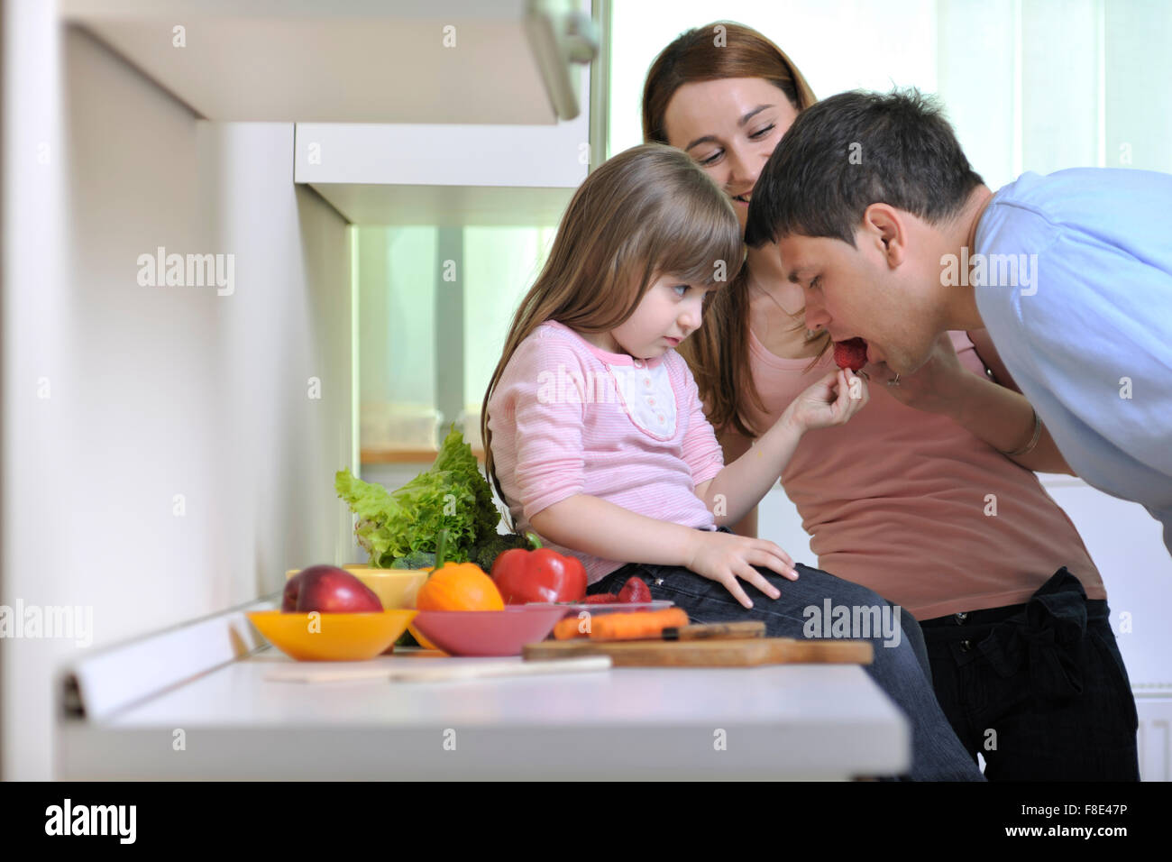 happy young family have lunch time with fresh fruits and vegetable food ...
