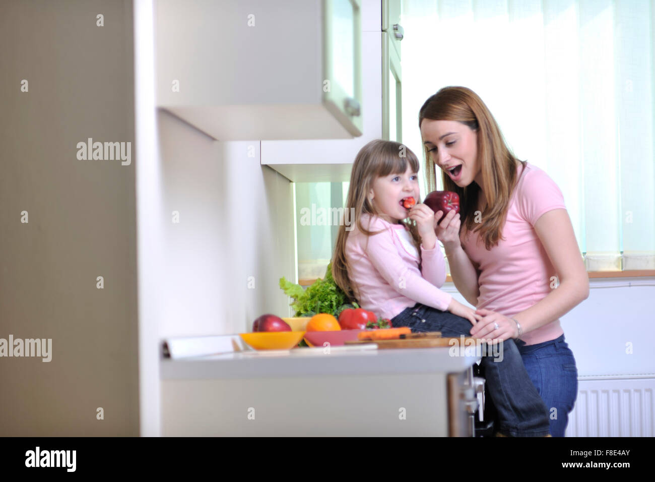 happy young family have lunch time with fresh fruits and vegetable food ...