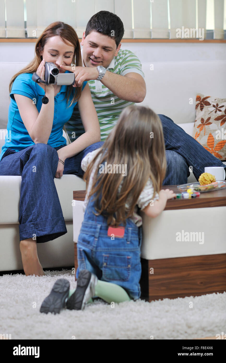 young happy family recording by video camera their child at home Stock ...