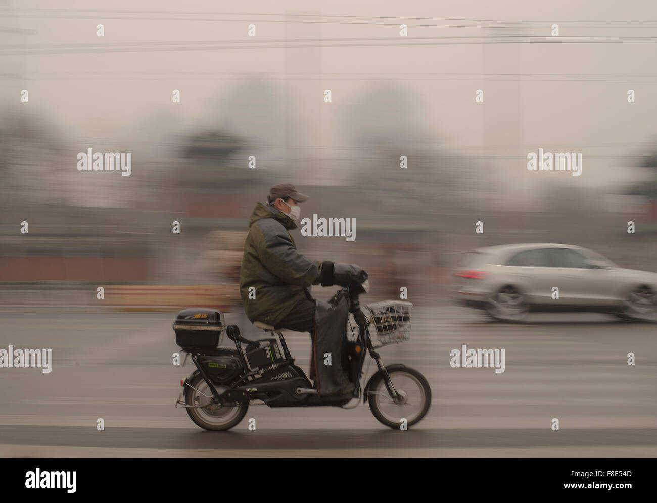 Commuters on a bike wear face masks as they speed along a road, braving ...