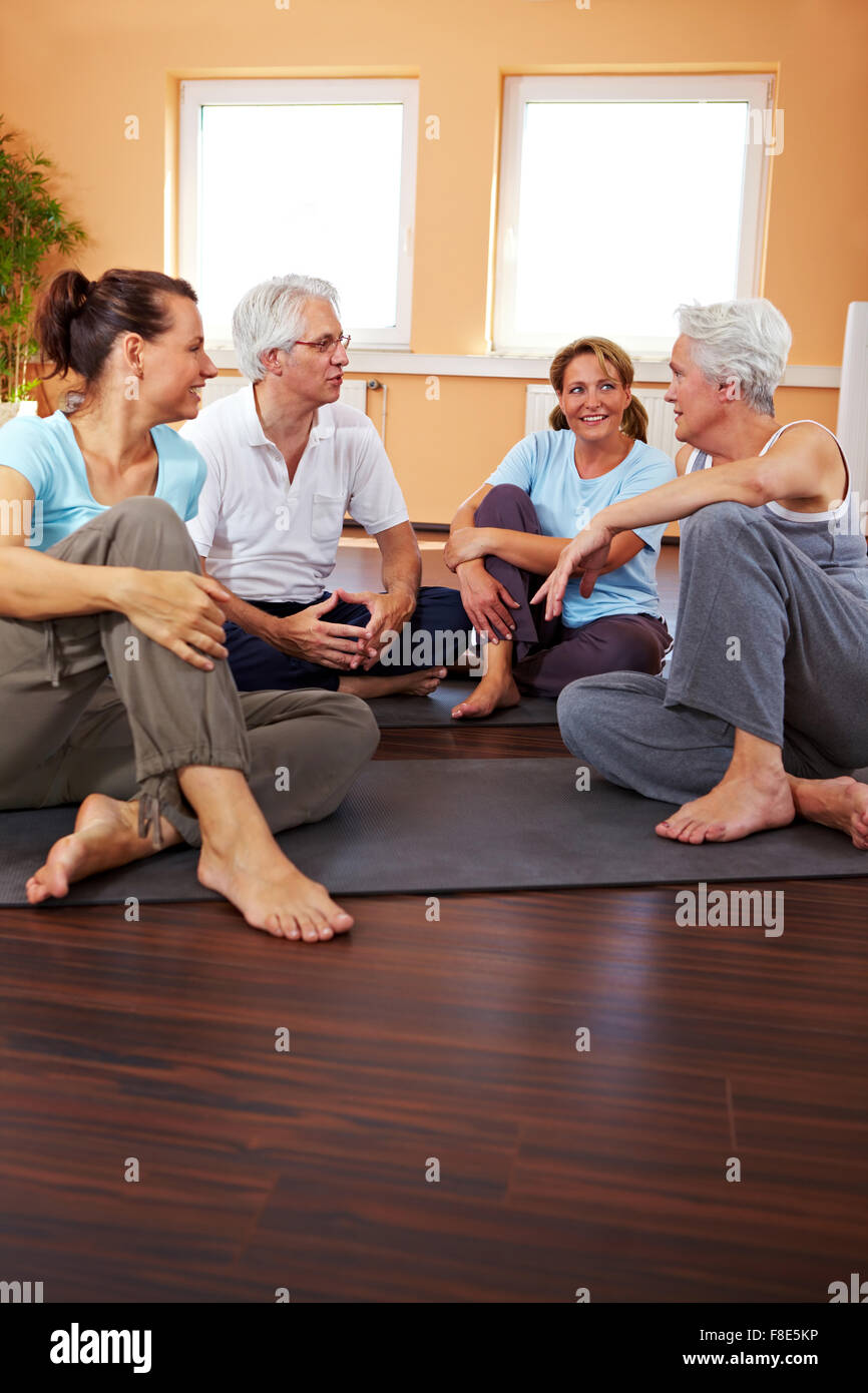 Fitness class sitting in gym and talking to each other Stock Photo - Alamy