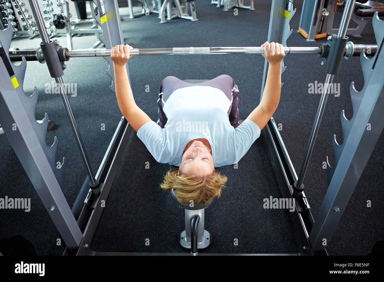 Woman lifting heavy weights in a gym Stock Photo - Alamy