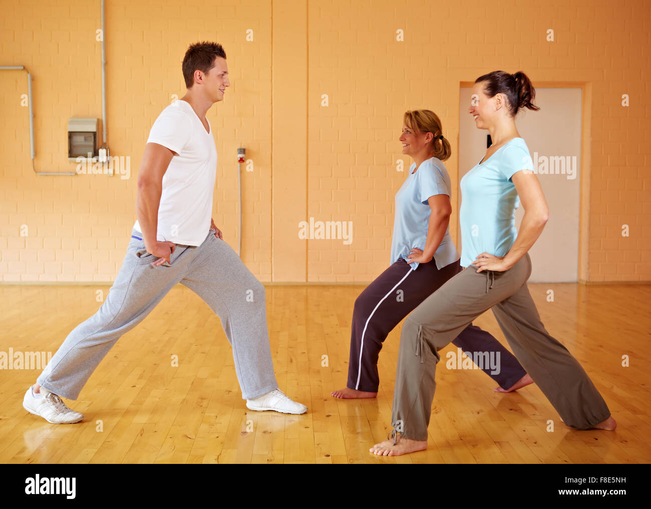 Two women exercising with their personal fitness trainer Stock Photo ...