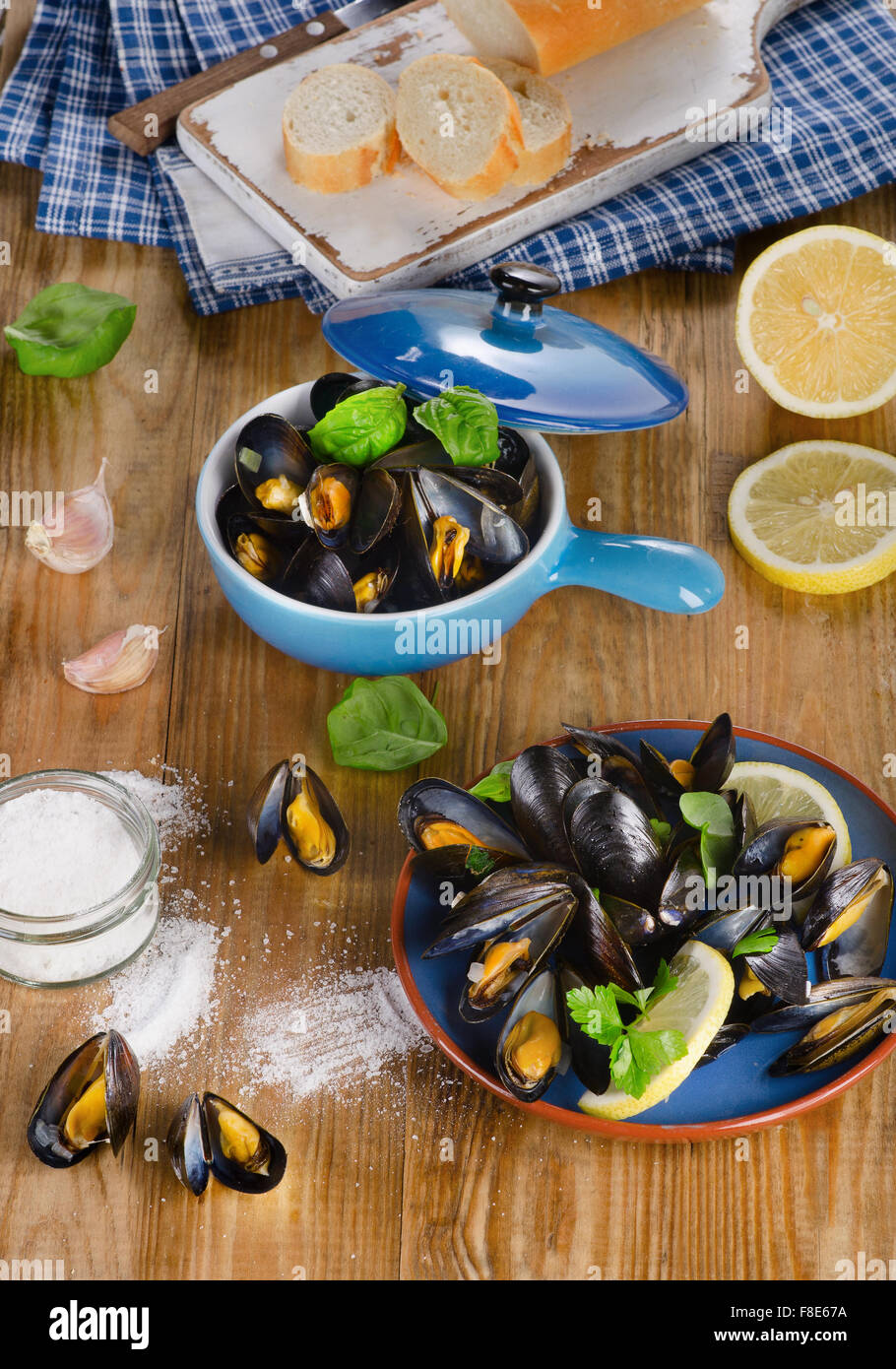 Plates of steamed mussels on wooden background. View from above Stock ...