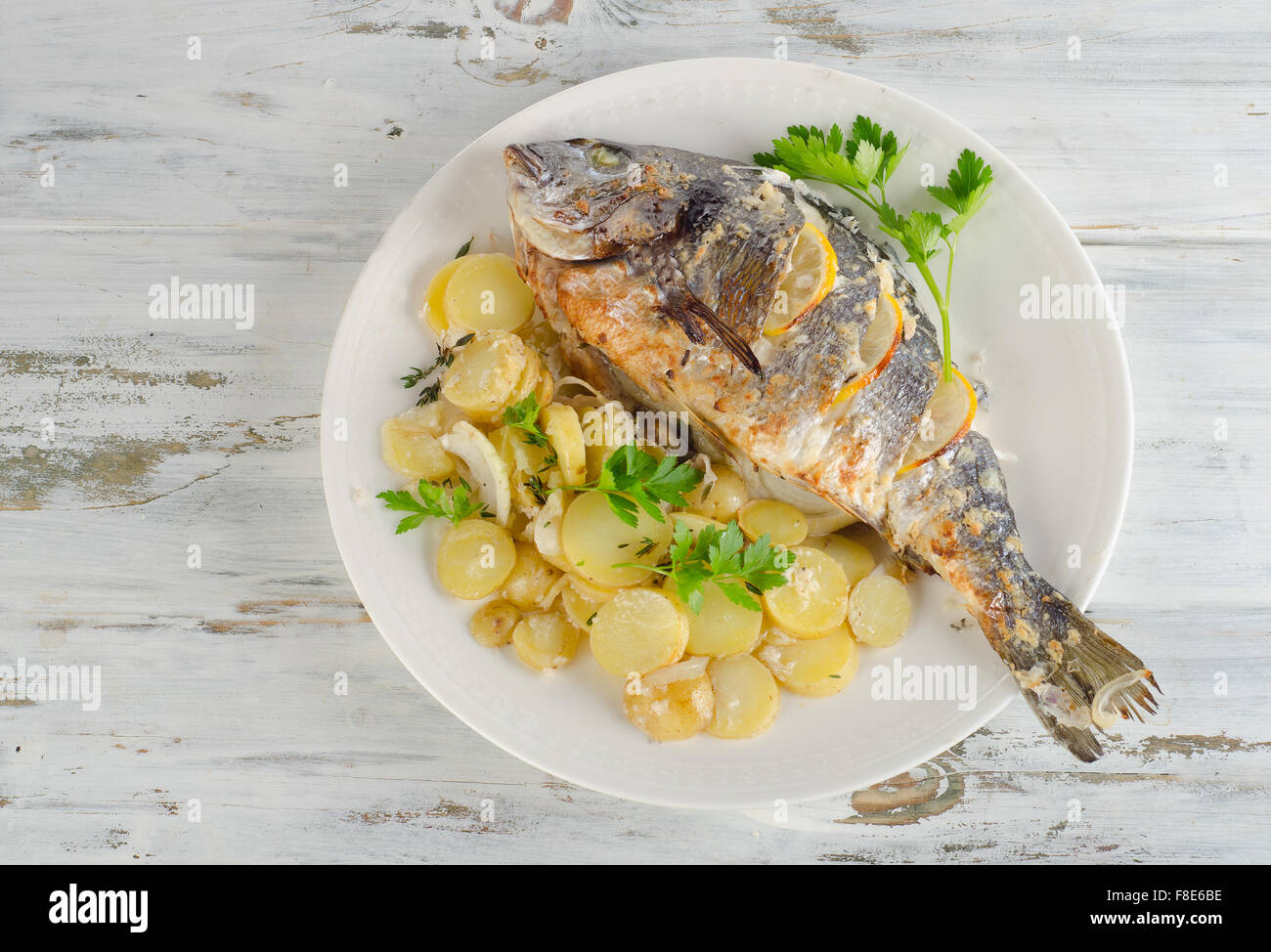 Fried fish with potatoes and lemon. Top view Stock Photo - Alamy