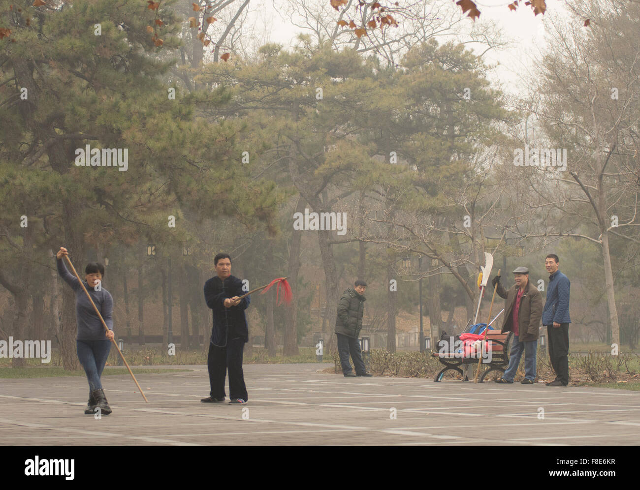 People without face masks exercise tai chi in a park, braving heavy air ...
