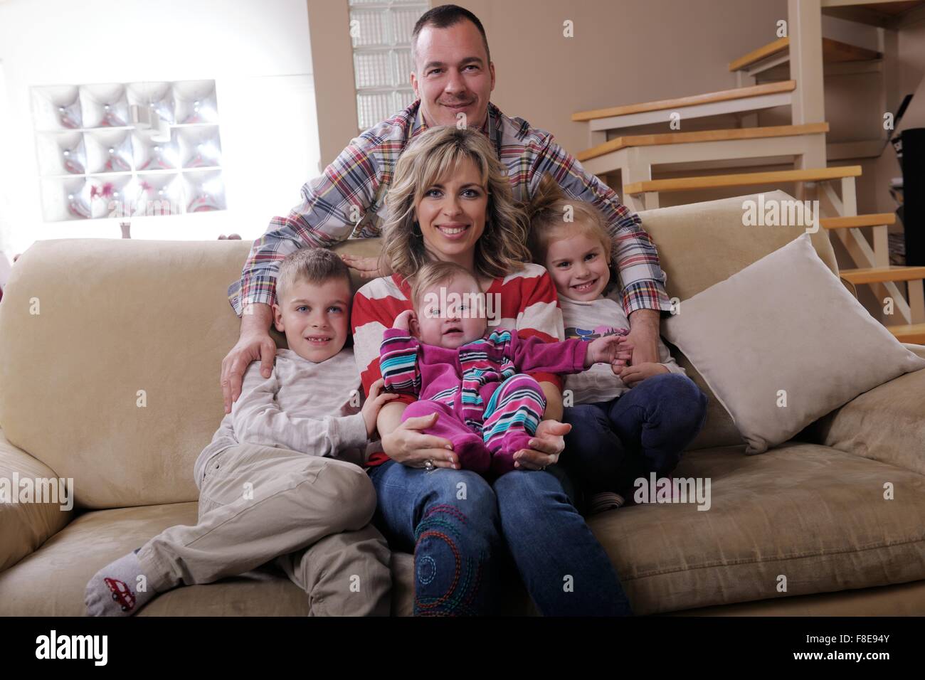 hapy young family have fun with their children at modern living room ...