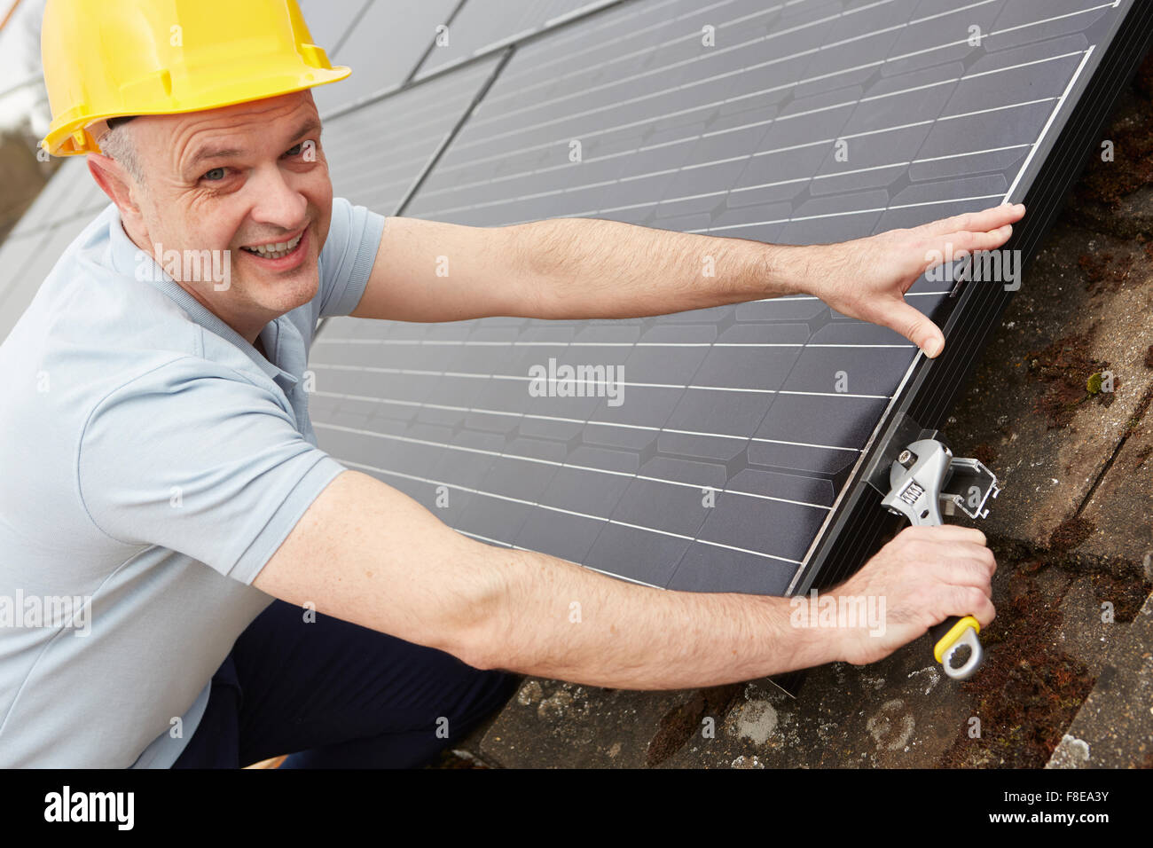 Engineer Installing Solar Panels On Roof Of House Stock Photo - Alamy