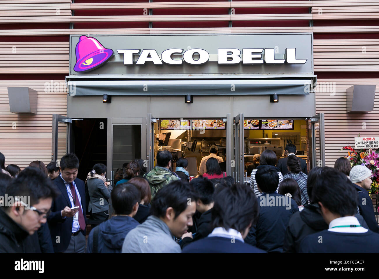 Customers line up outside the new Taco Bell branch at the Nippon ...