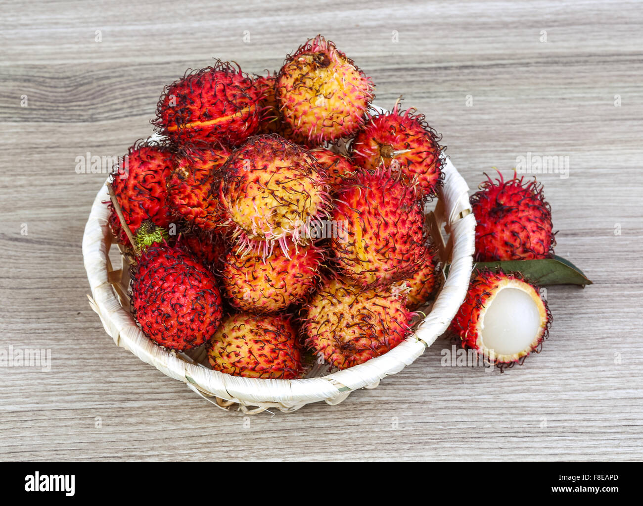 Asian fruit - rambutan - on the wood background Stock Photo - Alamy