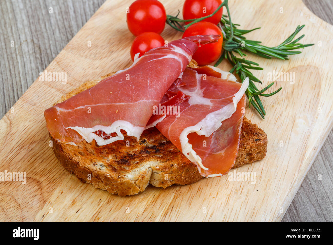 Spanish traditional snack - Jamon tapas with tomato and rosemary Stock ...