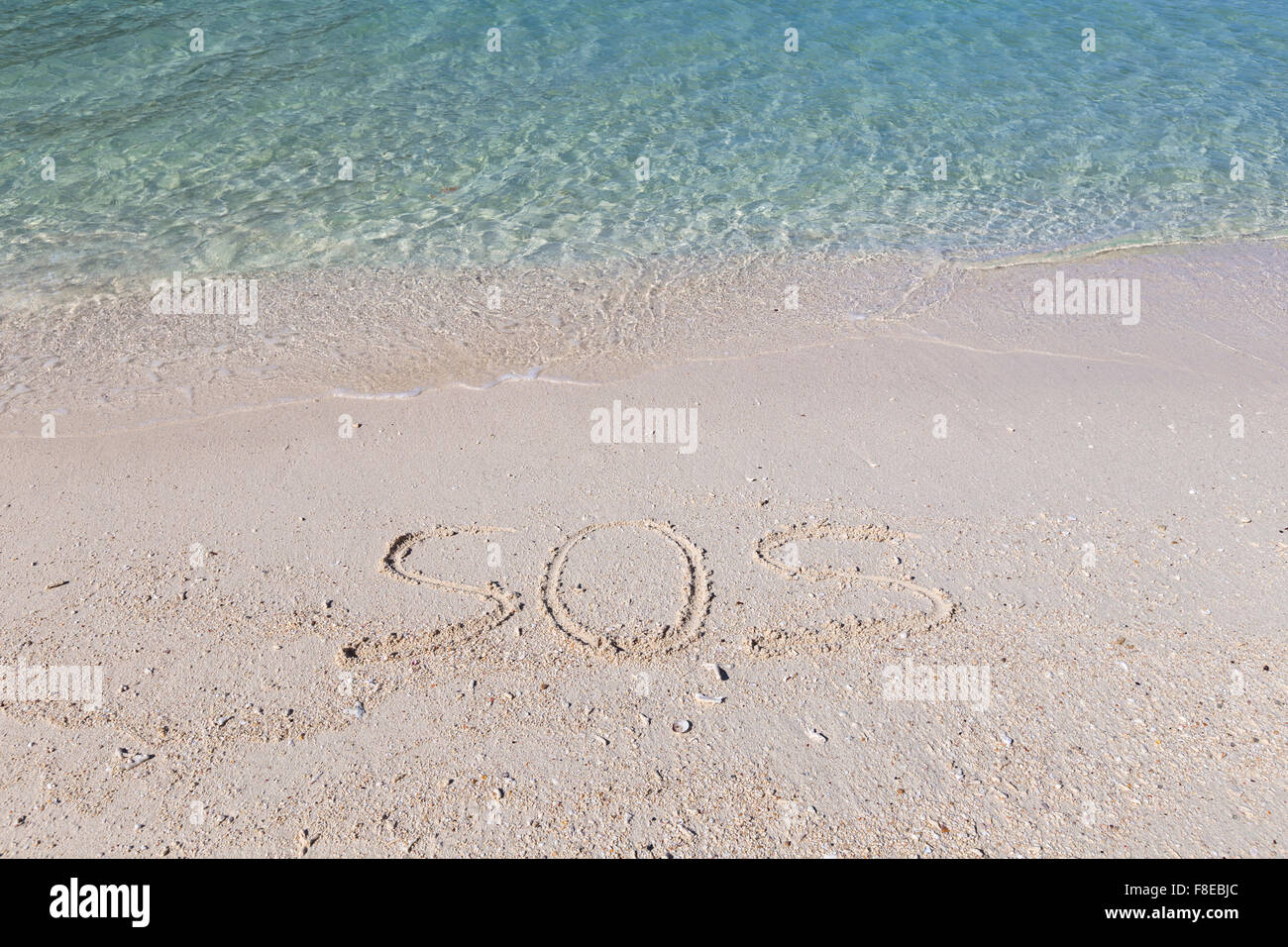 Sos message written on sand hi-res stock photography and images - Alamy