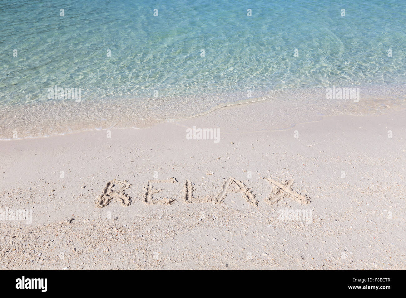 Relax written out in wet sand on a tropical beach in Thailand Stock ...