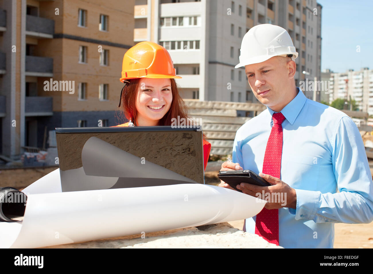 Portrait of two builders works at construction site Stock Photo - Alamy