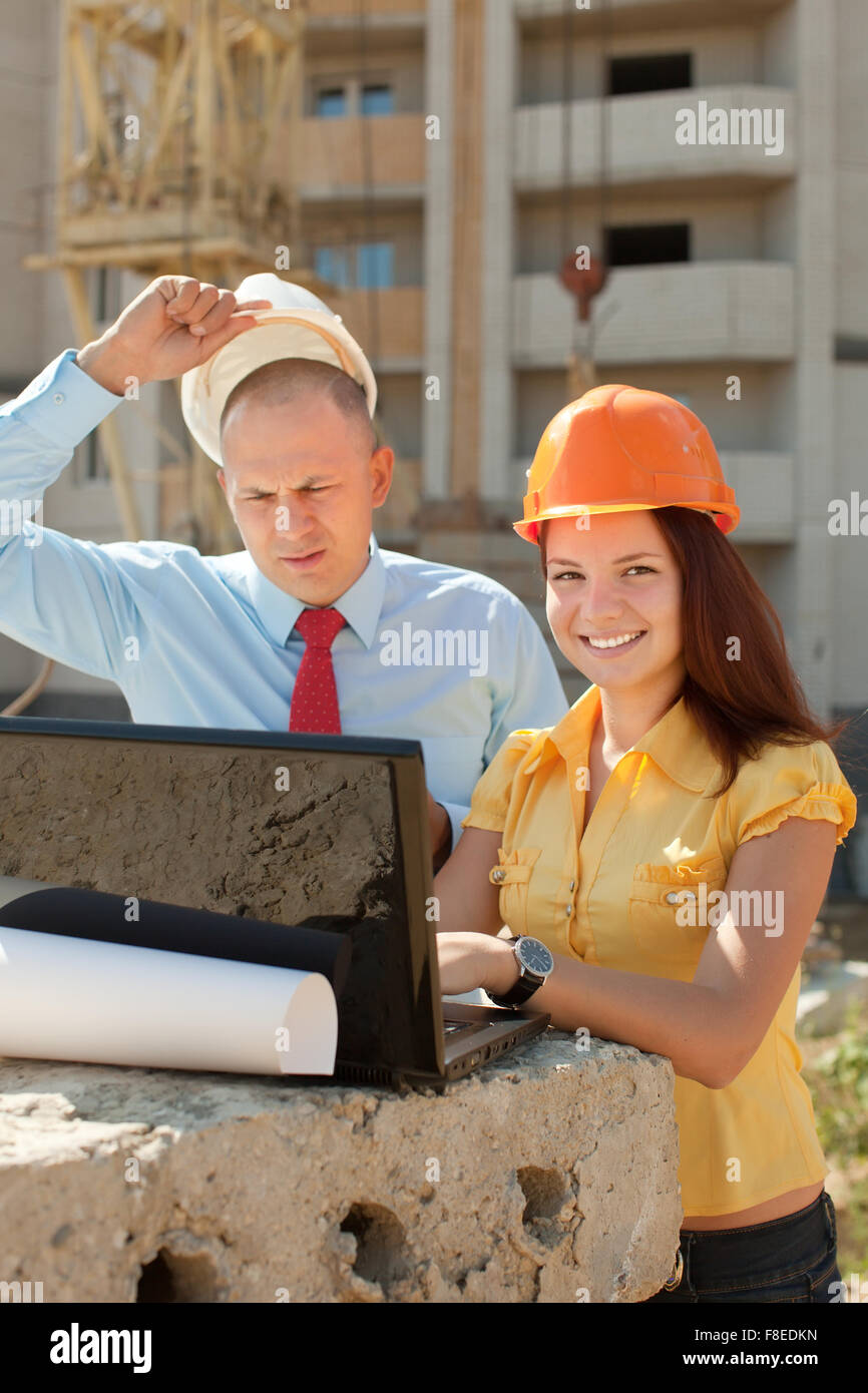 Portrait of two builders works at construction site Stock Photo - Alamy