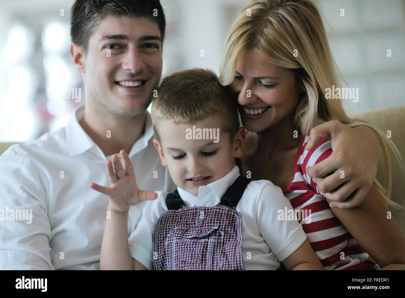 happy young family with kids in bright modern living room have fun and ...