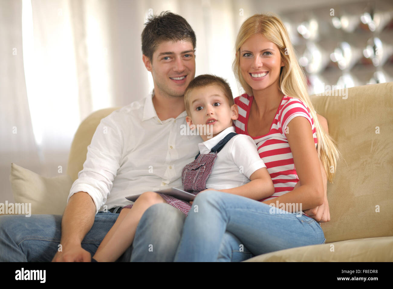 happy young family with kids in bright modern living room have fun and ...
