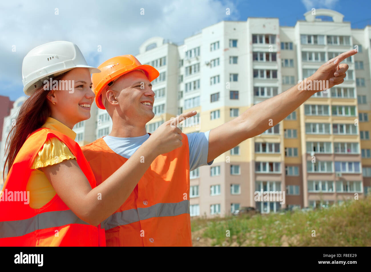 Portrait of two builders works at construction site Stock Photo - Alamy